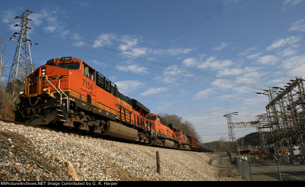 BNSF 7154 on oil train K12621 below grade next to the Reusens hydro plant transformer yard